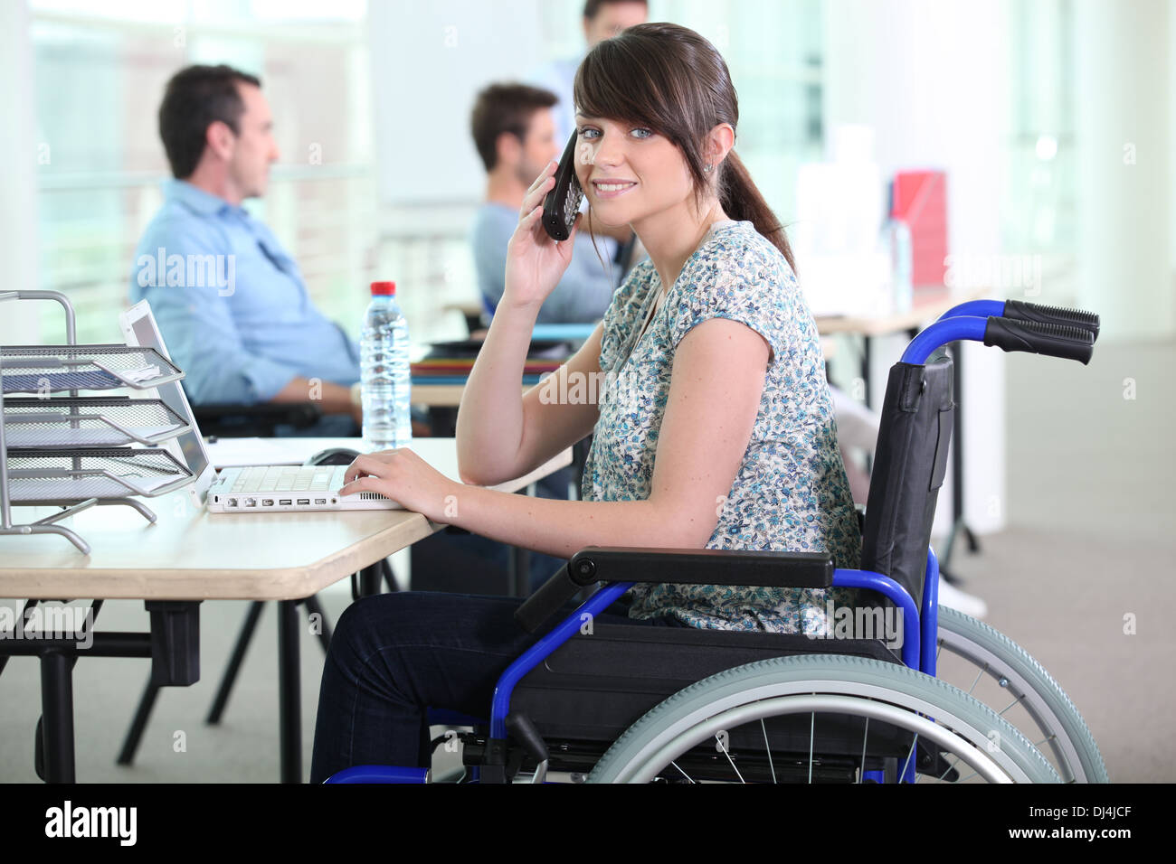 Disabled woman in office Stock Photo - Alamy