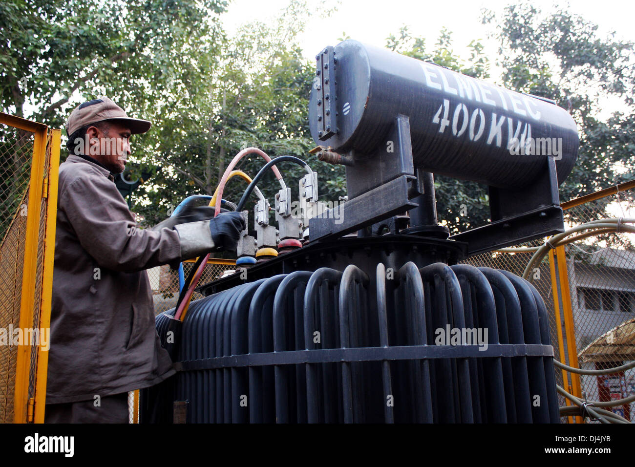 Lahore, Pakistan. 21st November 2013. A technician fixes an electricity ...