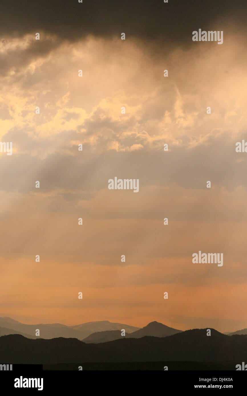 Rays of sunlight over mountain range Stock Photo - Alamy