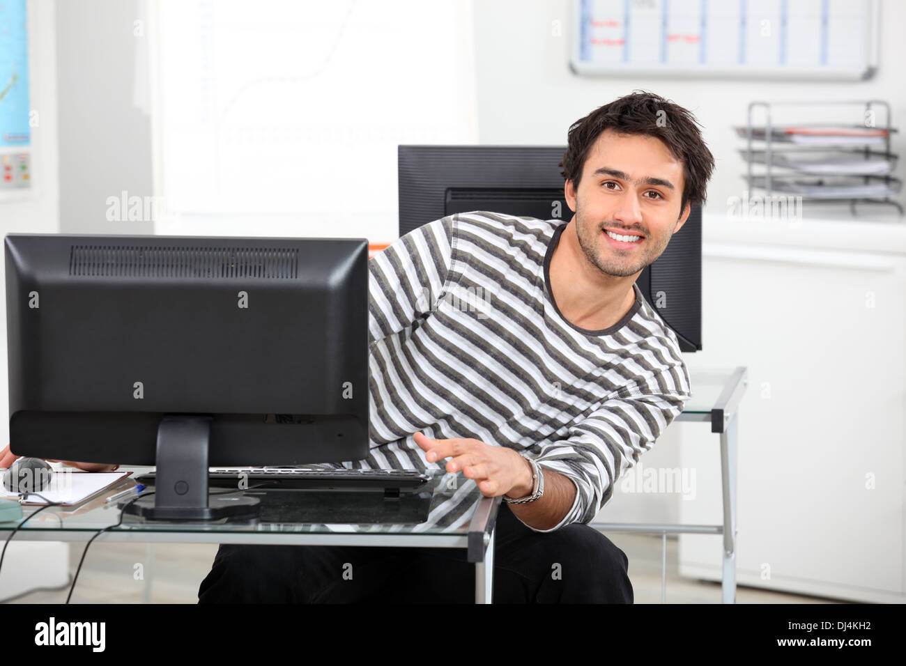 Young man at a computer Stock Photo - Alamy