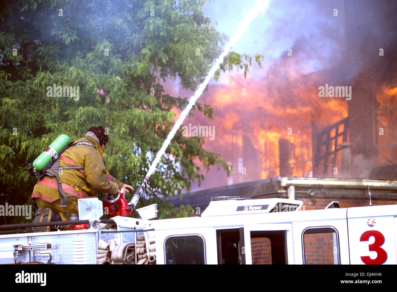 Fireman putting out a fire Stock Photo - Alamy