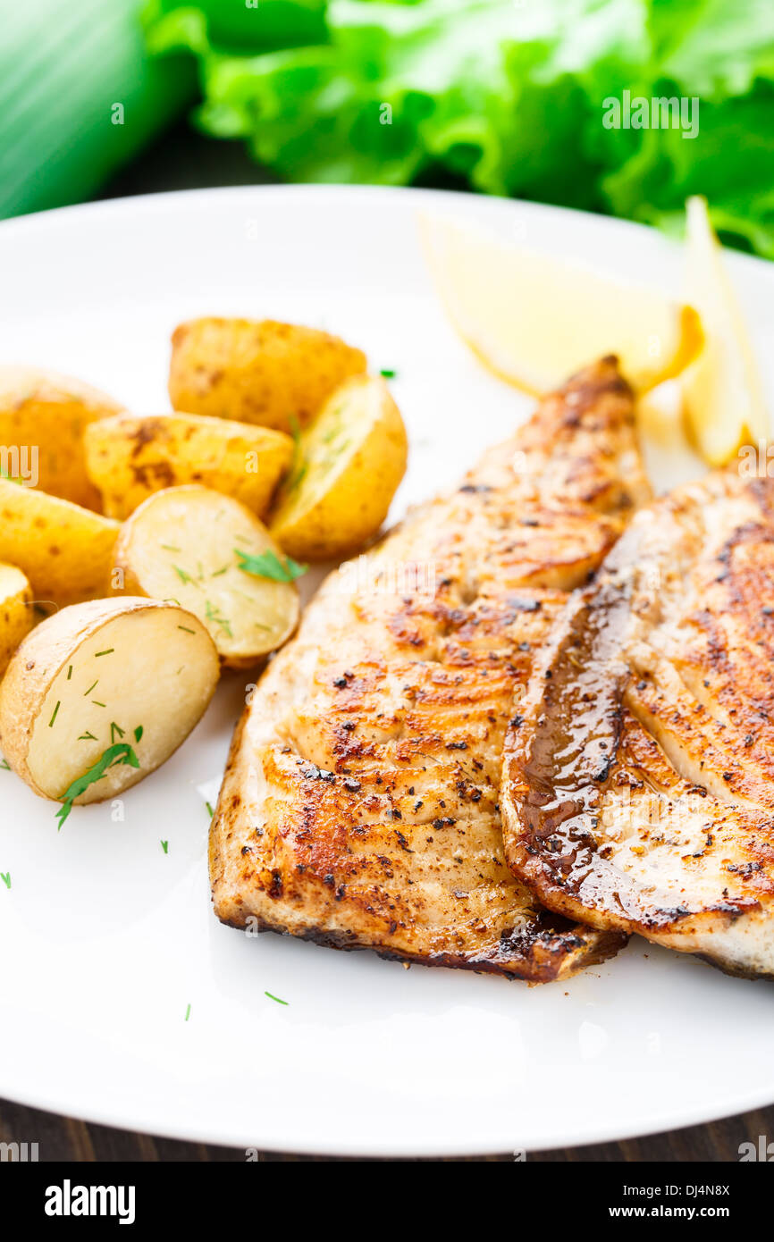Fried mackerel with baked potato Stock Photo - Alamy