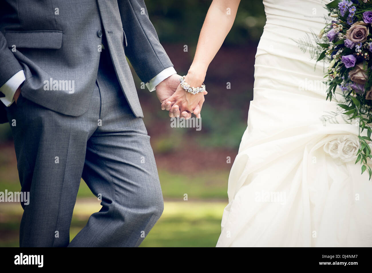 Bride and groom holding hands Stock Photo - Alamy