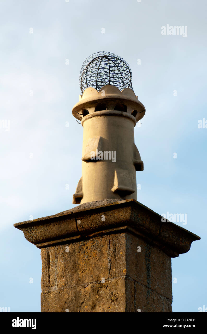Chimney pot with wire bird cowl Stock Photo - Alamy