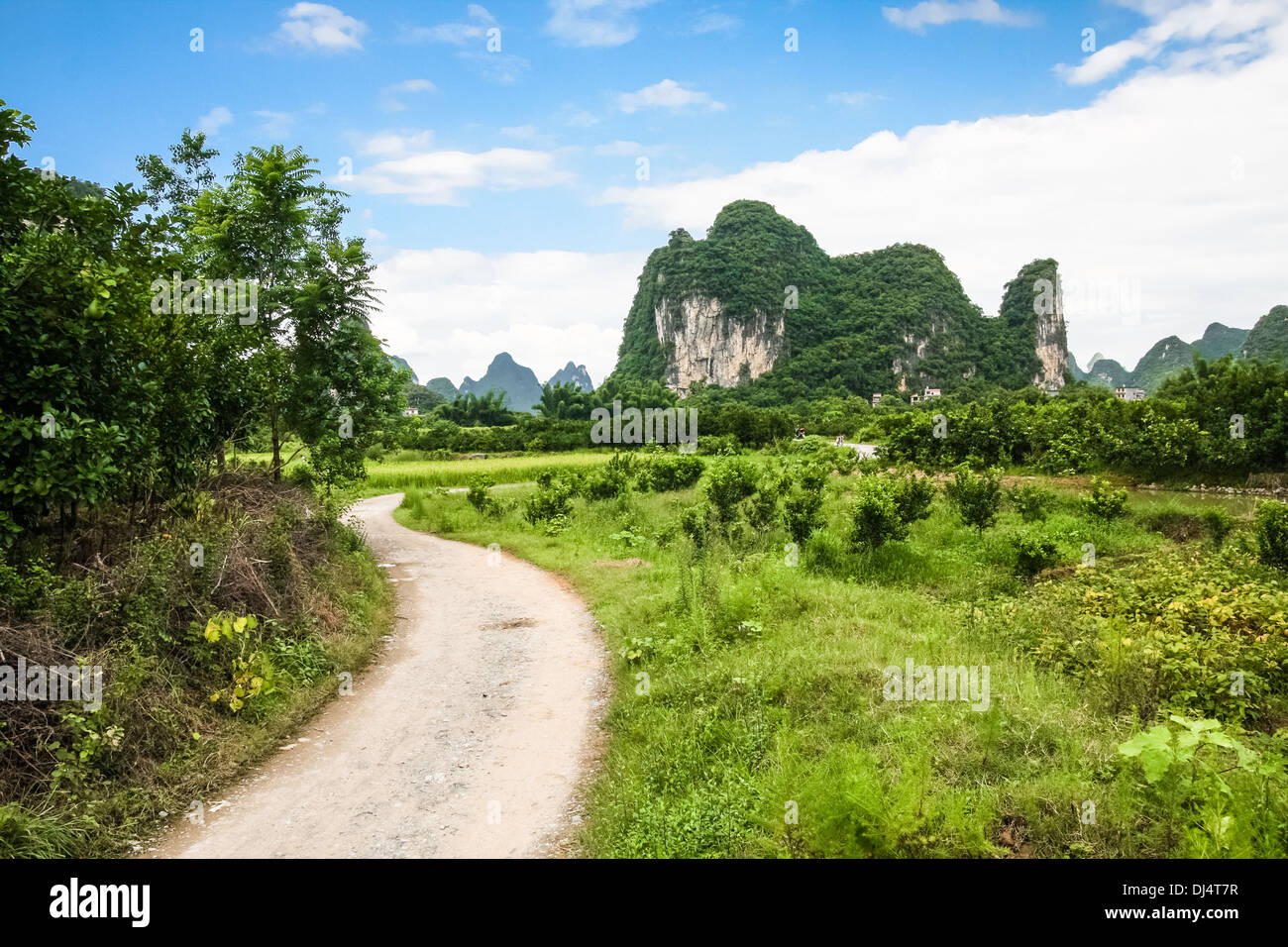 Road leading to limestone mountain in china Stock Photo - Alamy