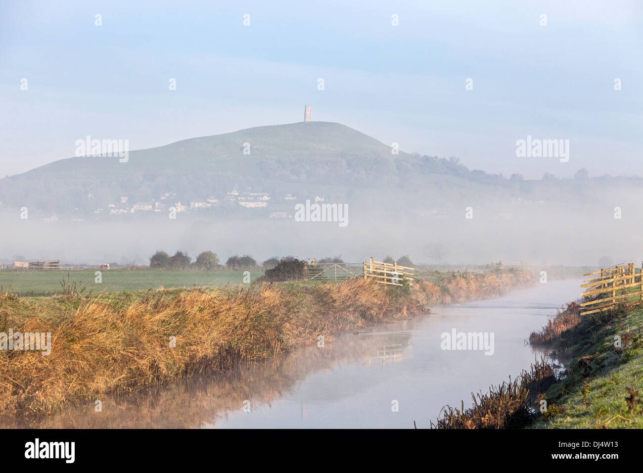 Early morning mist on the River Brue and the distant Glastonbury Tor ...