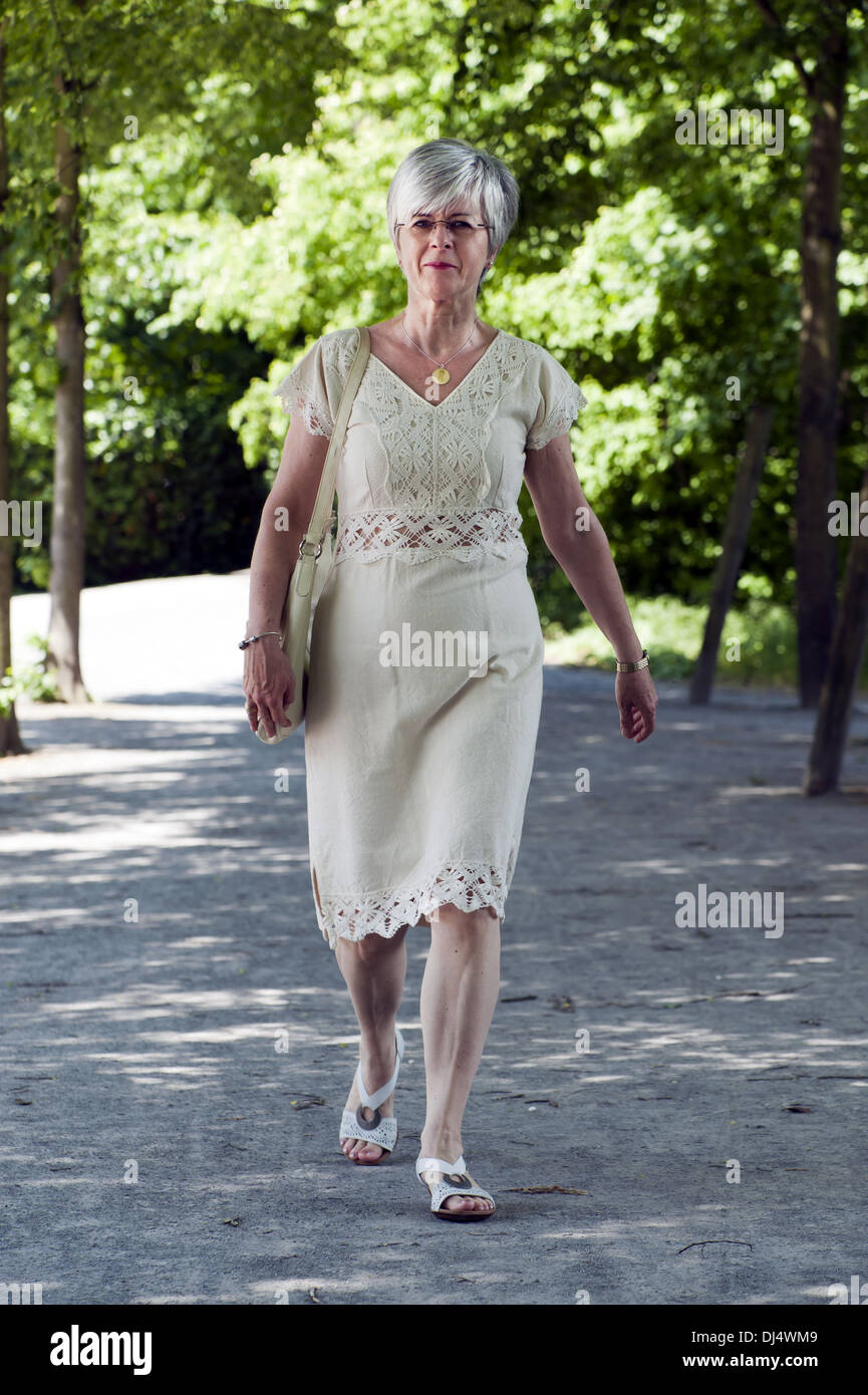Woman walking on a path Stock Photo - Alamy