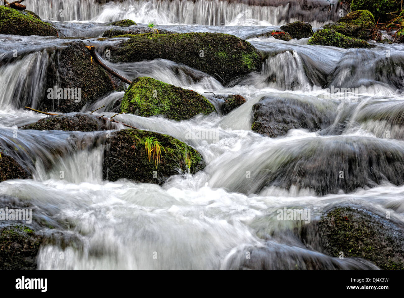 Water over the stone barrier Stock Photo - Alamy