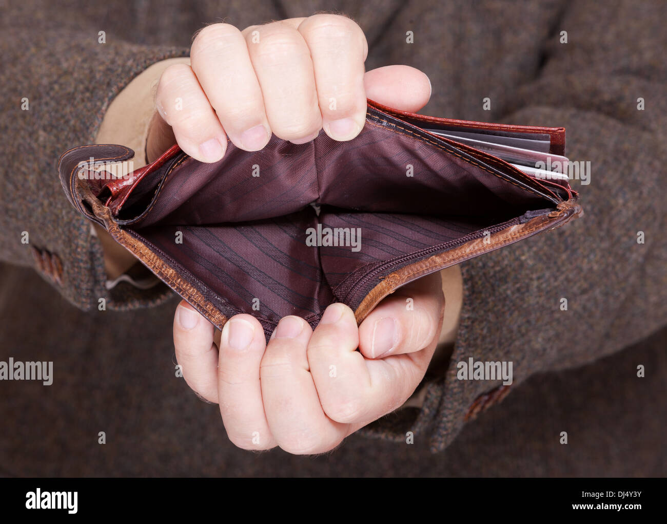 Broke businessman showing brown leather empty wallet. Business concept ...