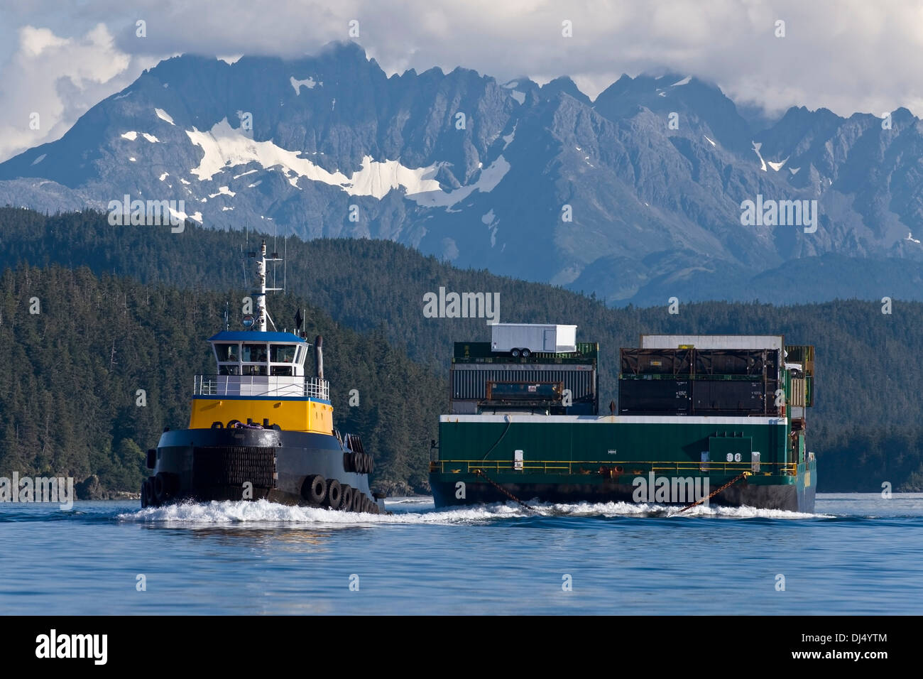 Tug Boat Pulls A Freight Barge Through The Waters Of Lynn Canal Near ...