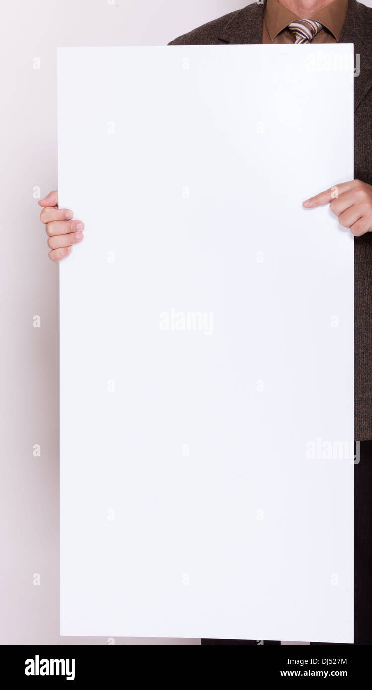 Advertising concept. Businessman holding blank sign empty billboard ...