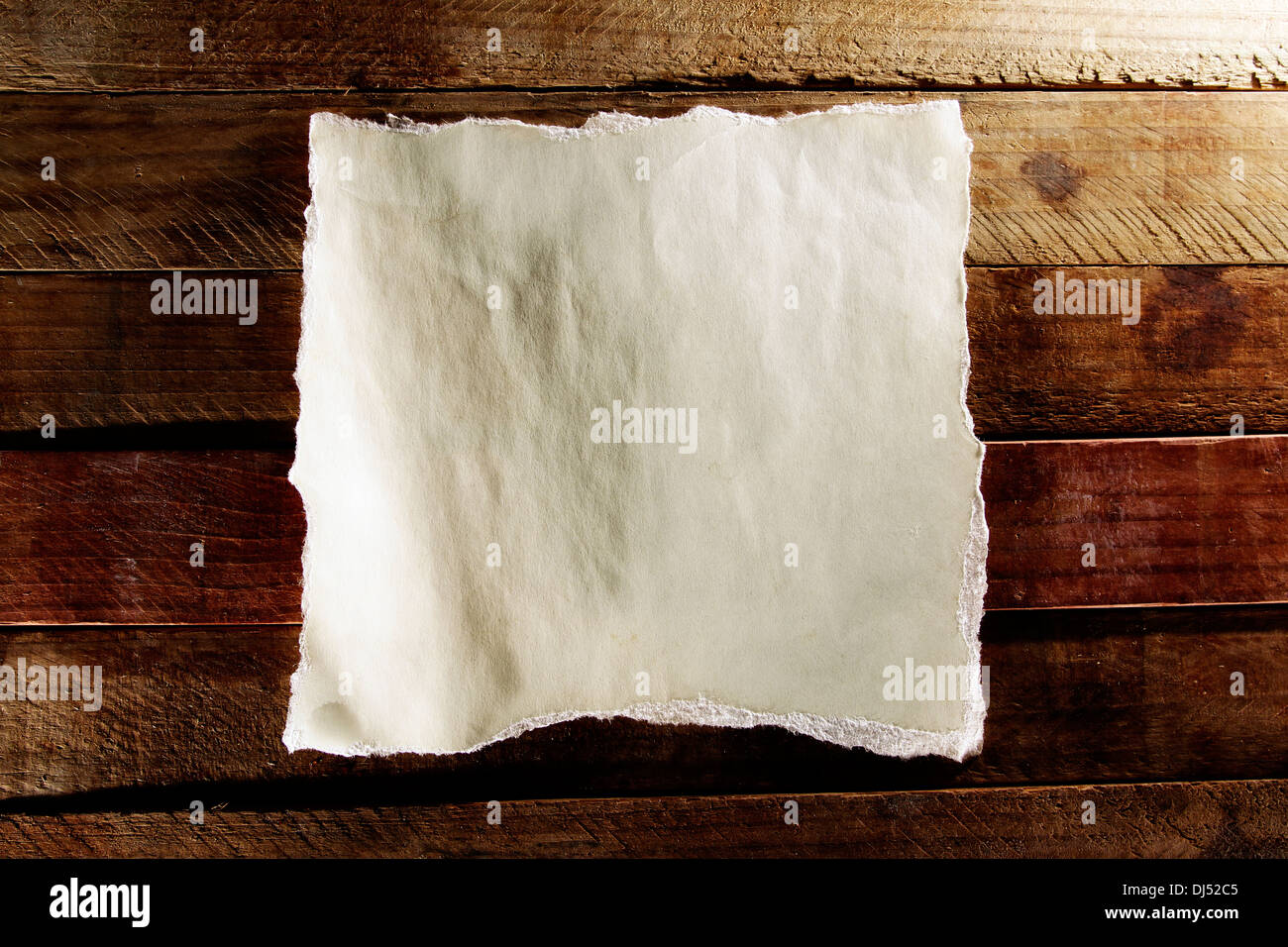 Piece of torn paper on boards Stock Photo - Alamy