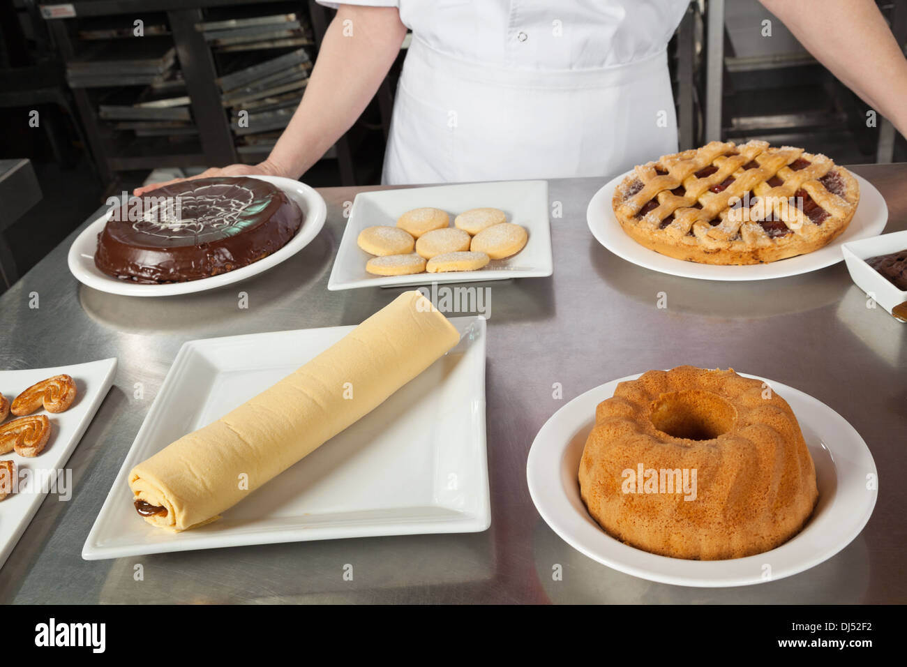Female Chef With Variety Of Sweet Dishes Stock Photo - Alamy