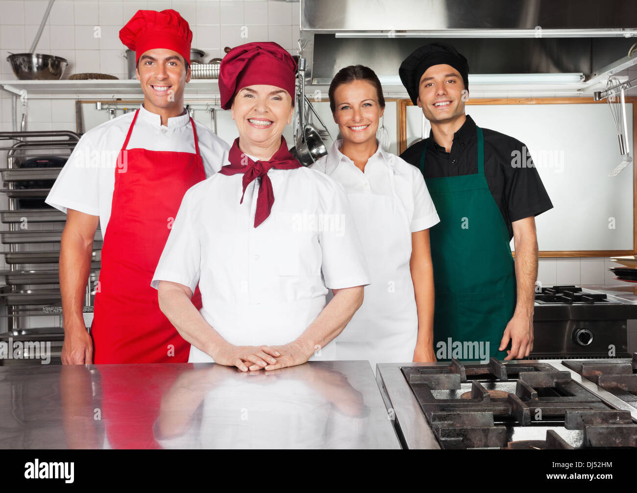 Happy Chefs Standing Together In Kitchen Stock Photo - Alamy