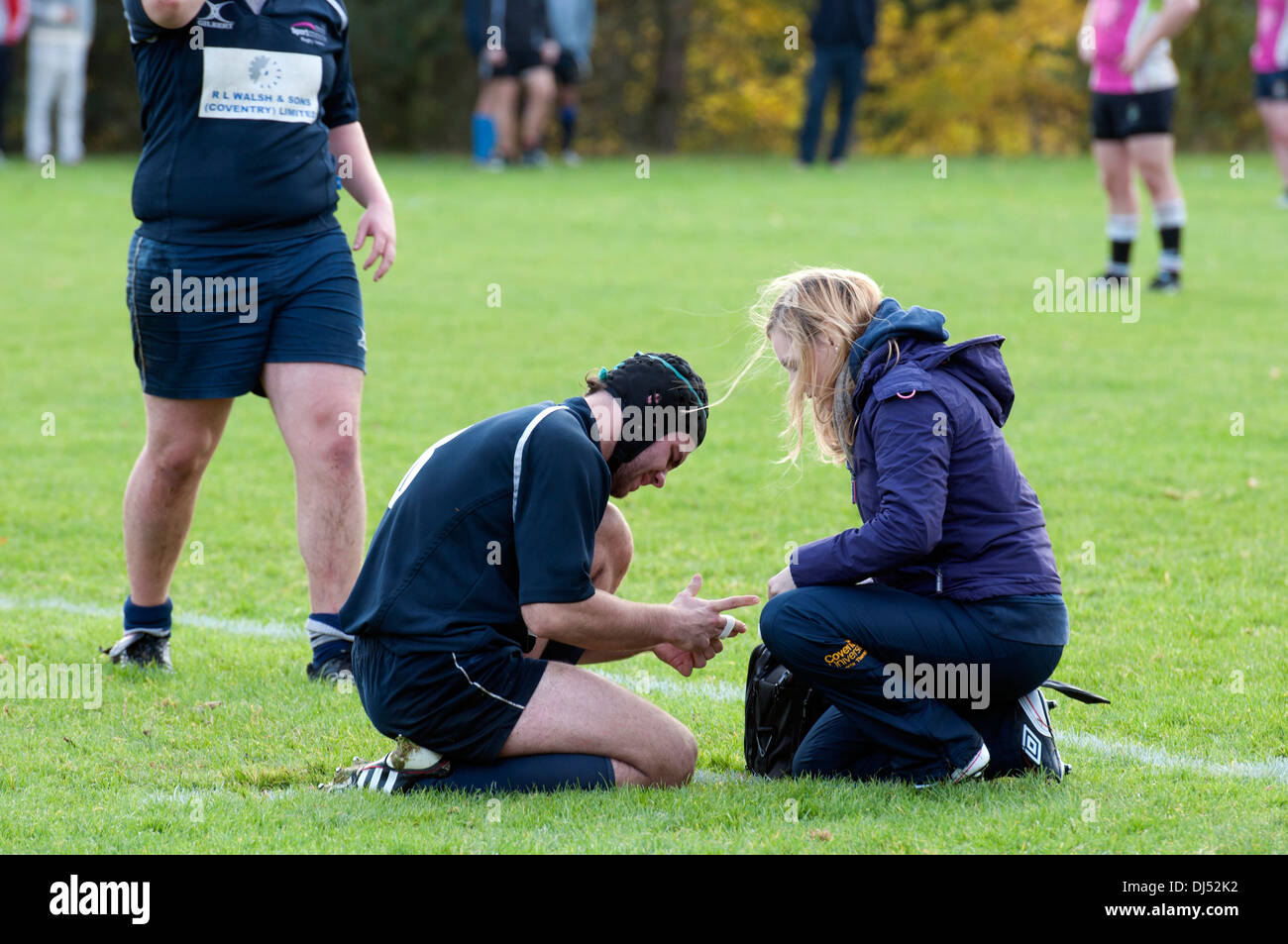 University sport, men`s Rugby Union, injured player receiving first aid ...