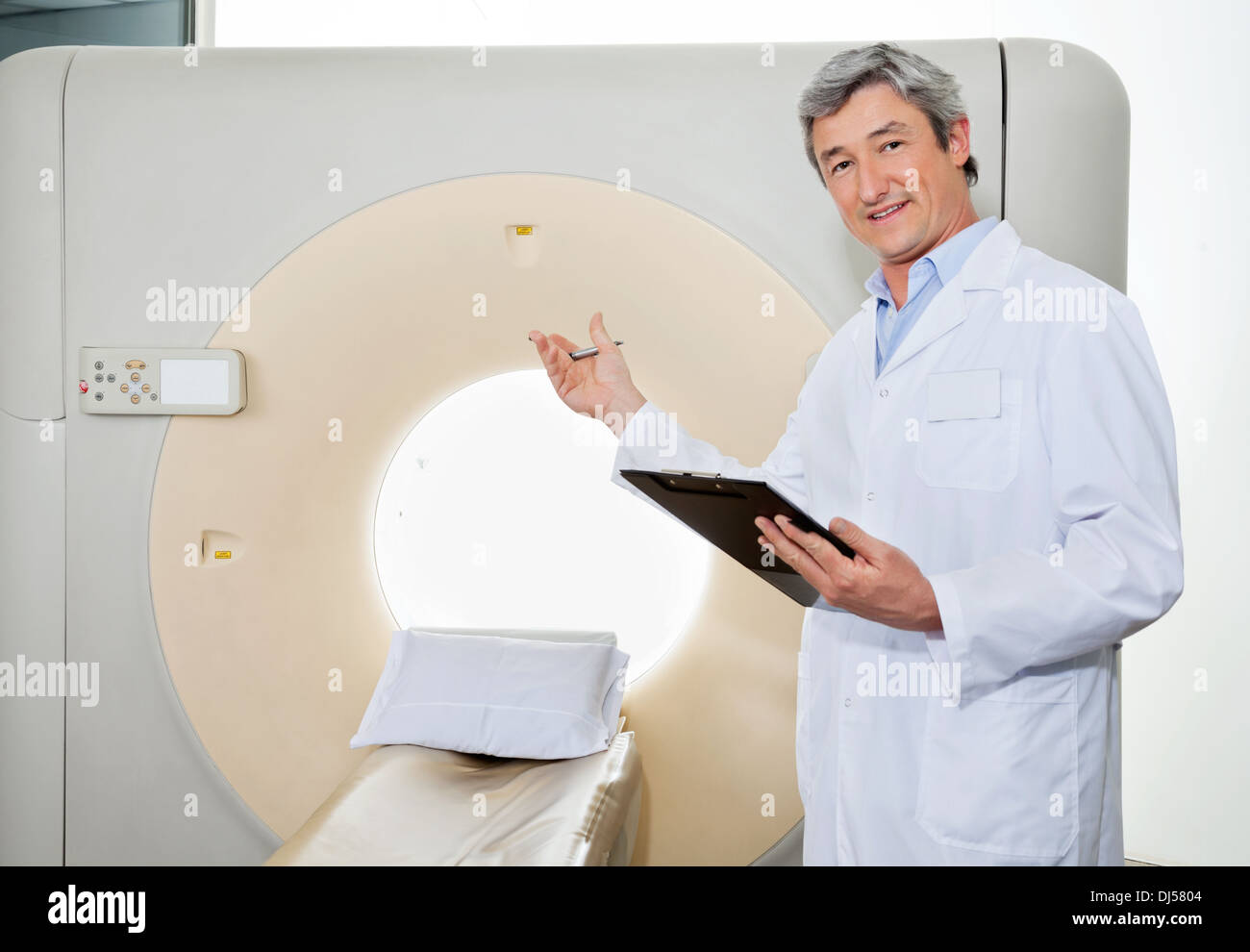 Male Doctor Presenting The CT Scan Machine Stock Photo - Alamy