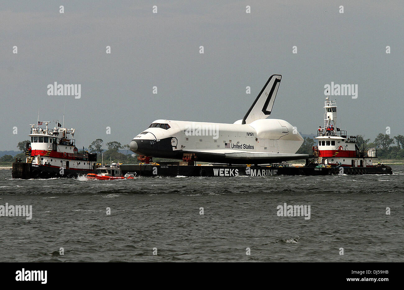 Space Shuttle Enterprise is carried by barge underneath The Gil Hodges ...