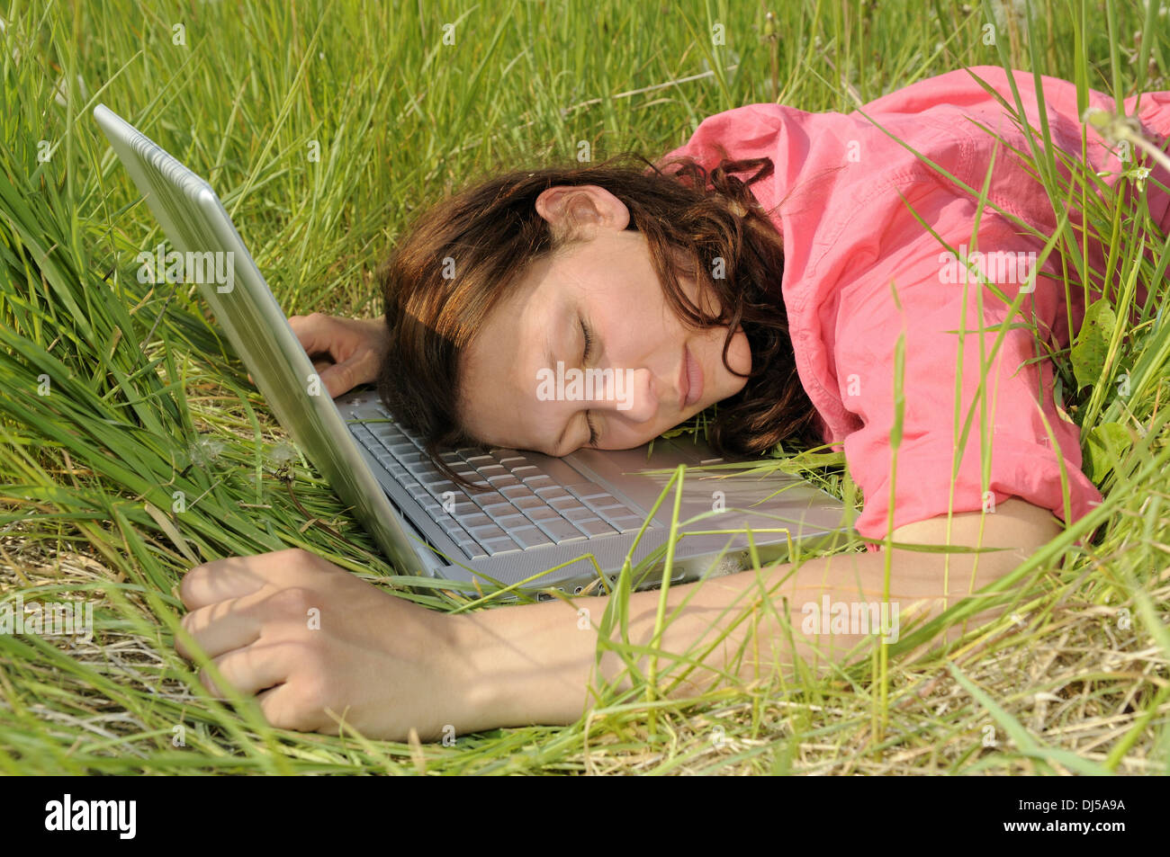 young woman sleeping on laptop Stock Photo - Alamy