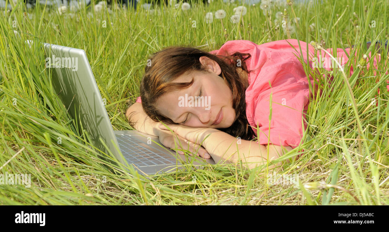 young woman sleeping on laptop Stock Photo - Alamy