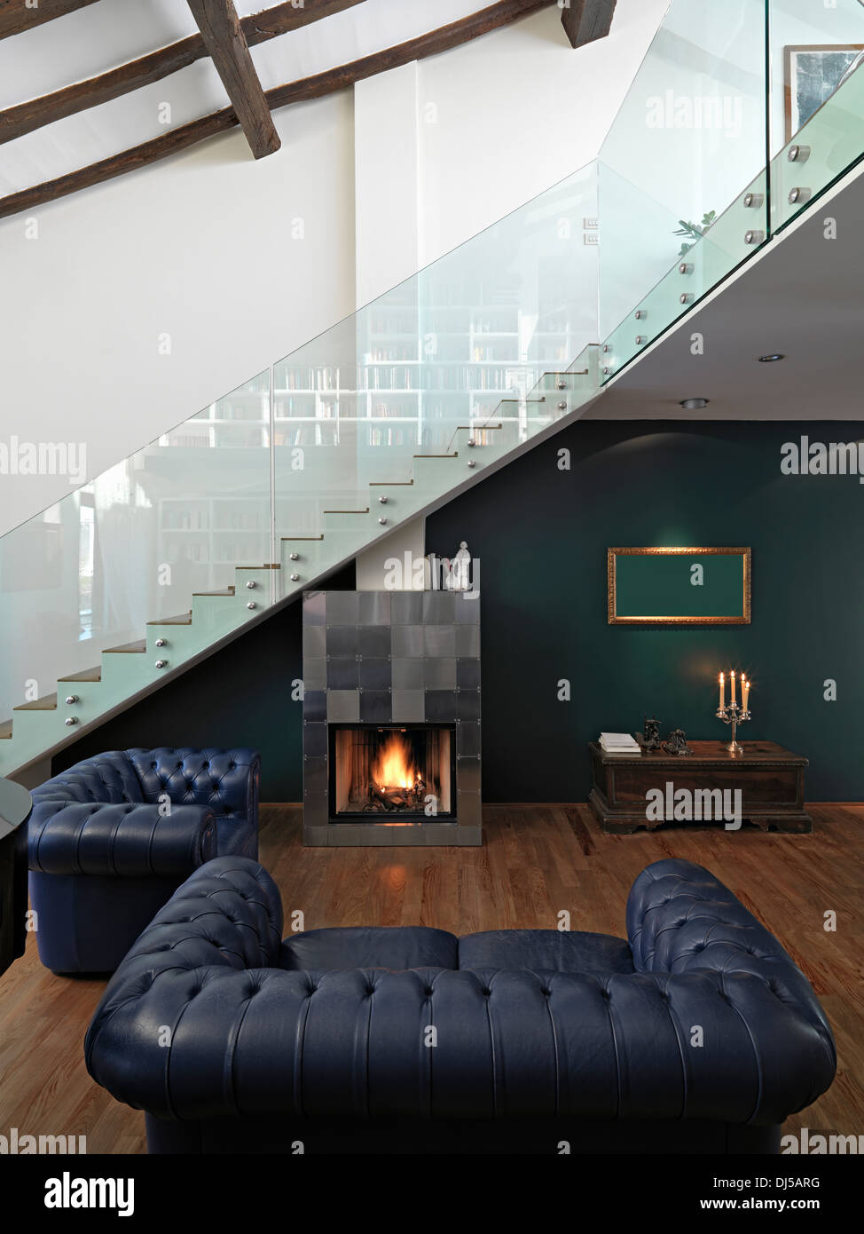modern living room in the attic with fireplace, wood floor and ...