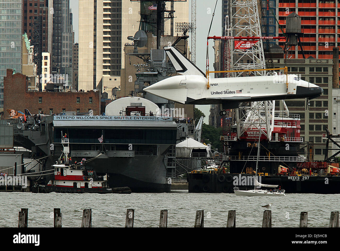 The NASA space shuttle prototype Enterprise is lowered by crane into ...