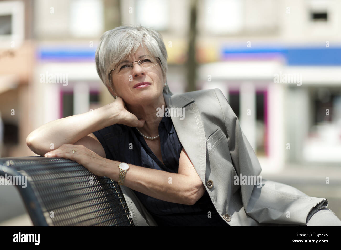 neat lady sitting on a bench Stock Photo - Alamy