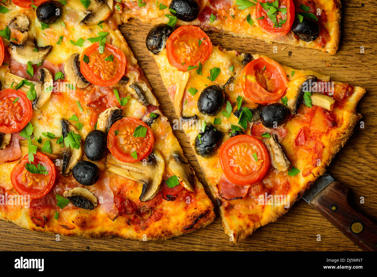 traditional italian homemade pizza with tomatoes, olives and mushrooms ...