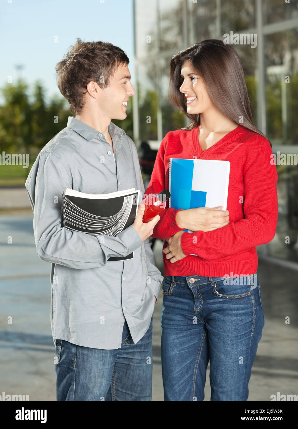 Students With Books Looking At Each Other On Campus Stock Photo - Alamy