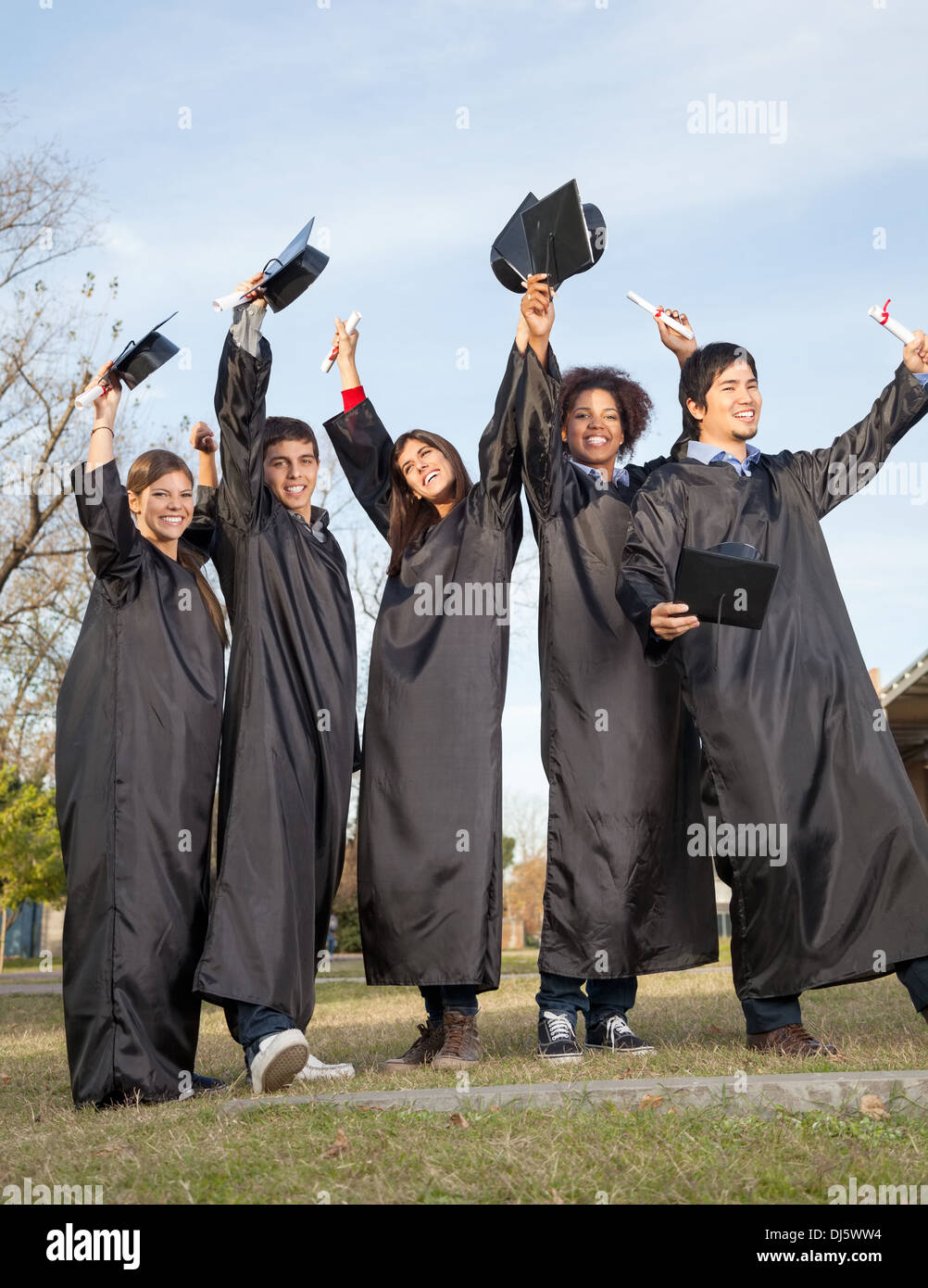 Students With Diplomas Celebrating Success On Graduation Day At Stock ...