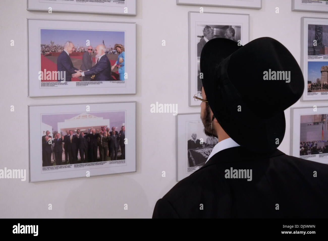 An Orthodox Jew looks at historic photographs depicting peace agreement ...