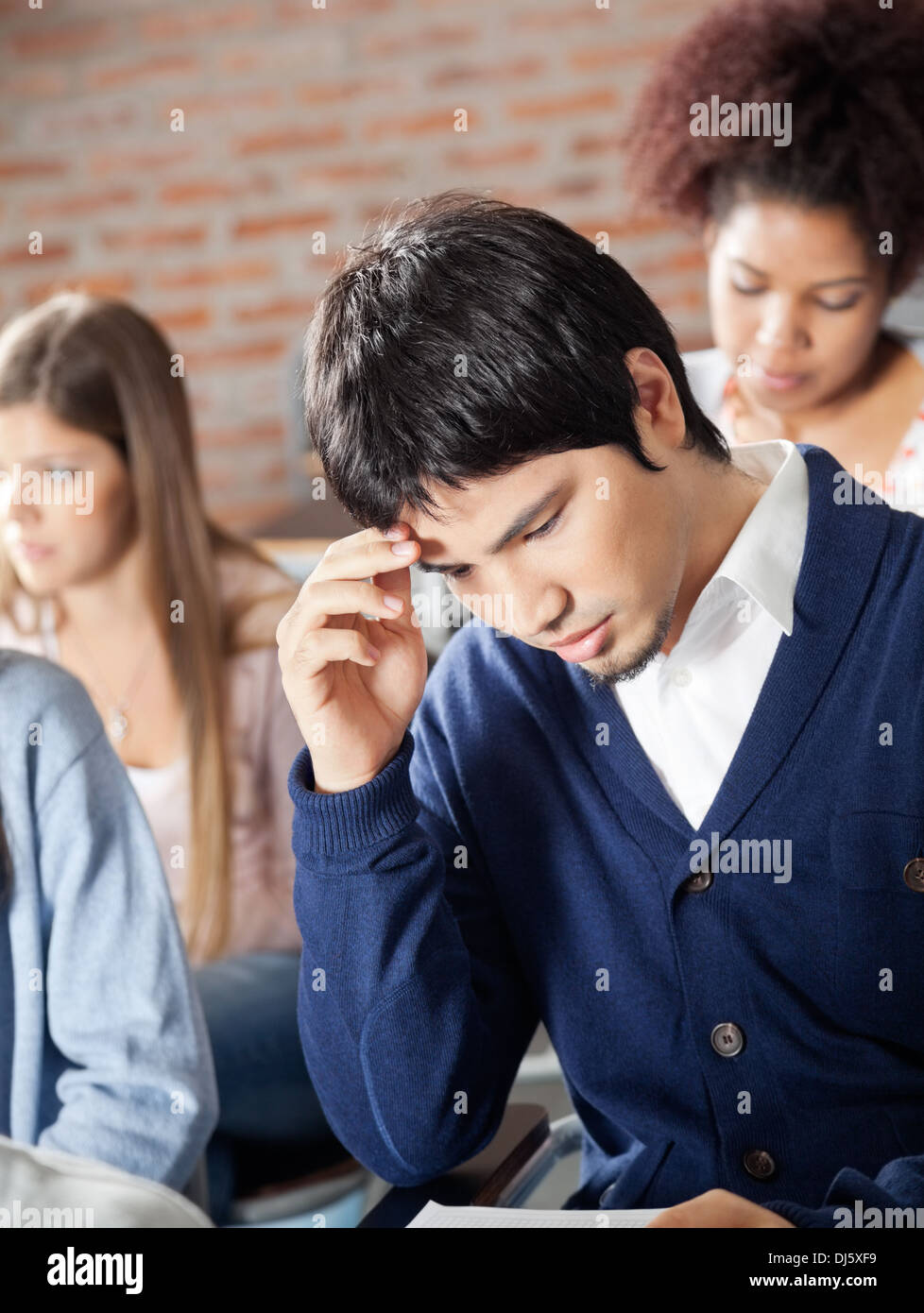 Student Thinking With Classmates In Classroom Stock Photo - Alamy