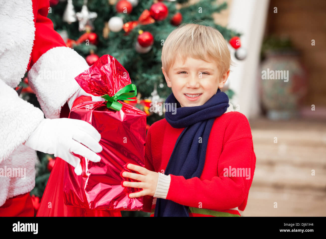 Boy Taking Gift From Santa Claus Stock Photo - Alamy