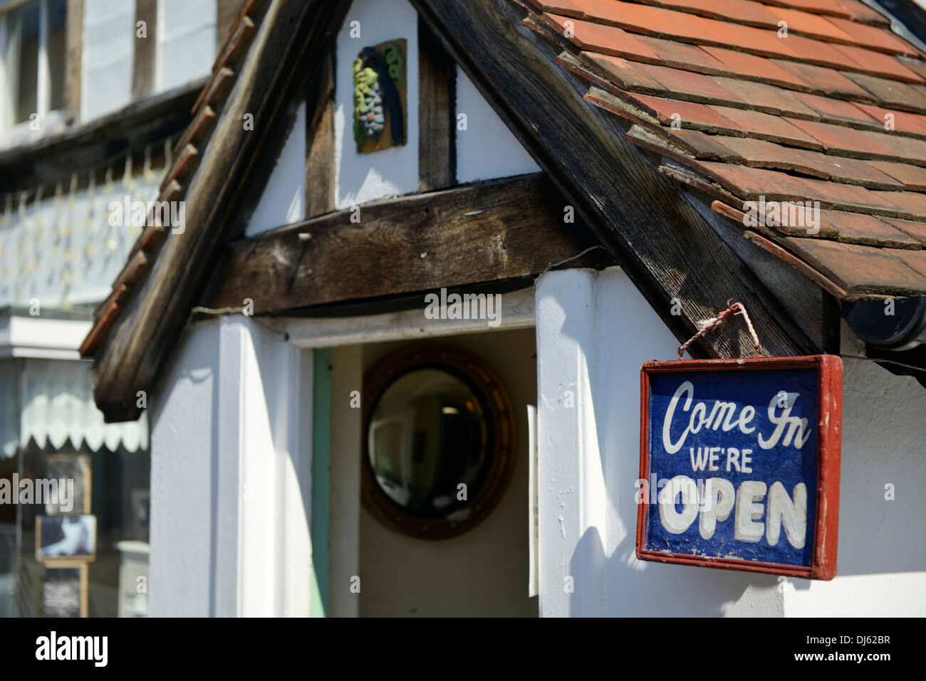 Old sign outside an antique shop, Fish Hill, Holt, Norfolk, England ...