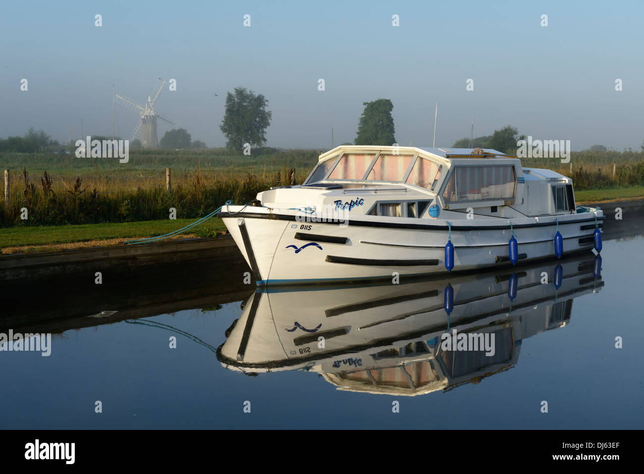 Pleasure boat with windmill in the background, Thurne Dyke, river ...