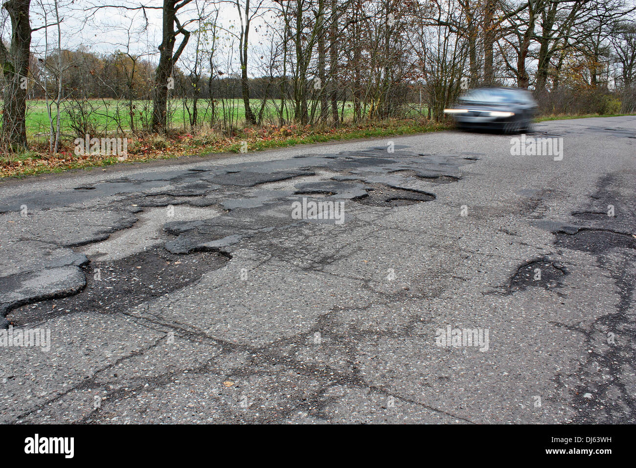 Car runs over holes and dangerous road Stock Photo - Alamy