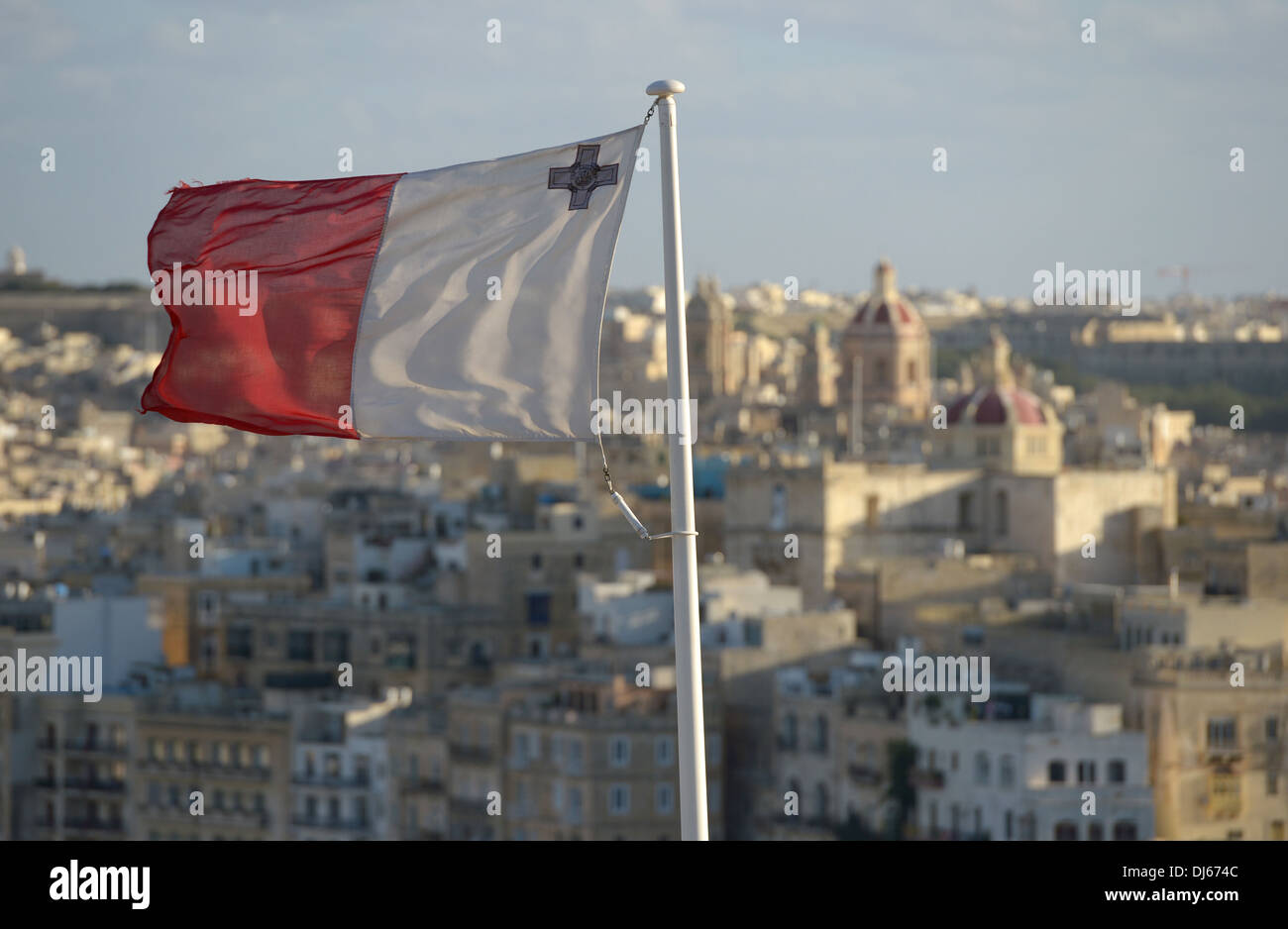 Flag of Malta with George Cross with the old city of Senglea in the ...