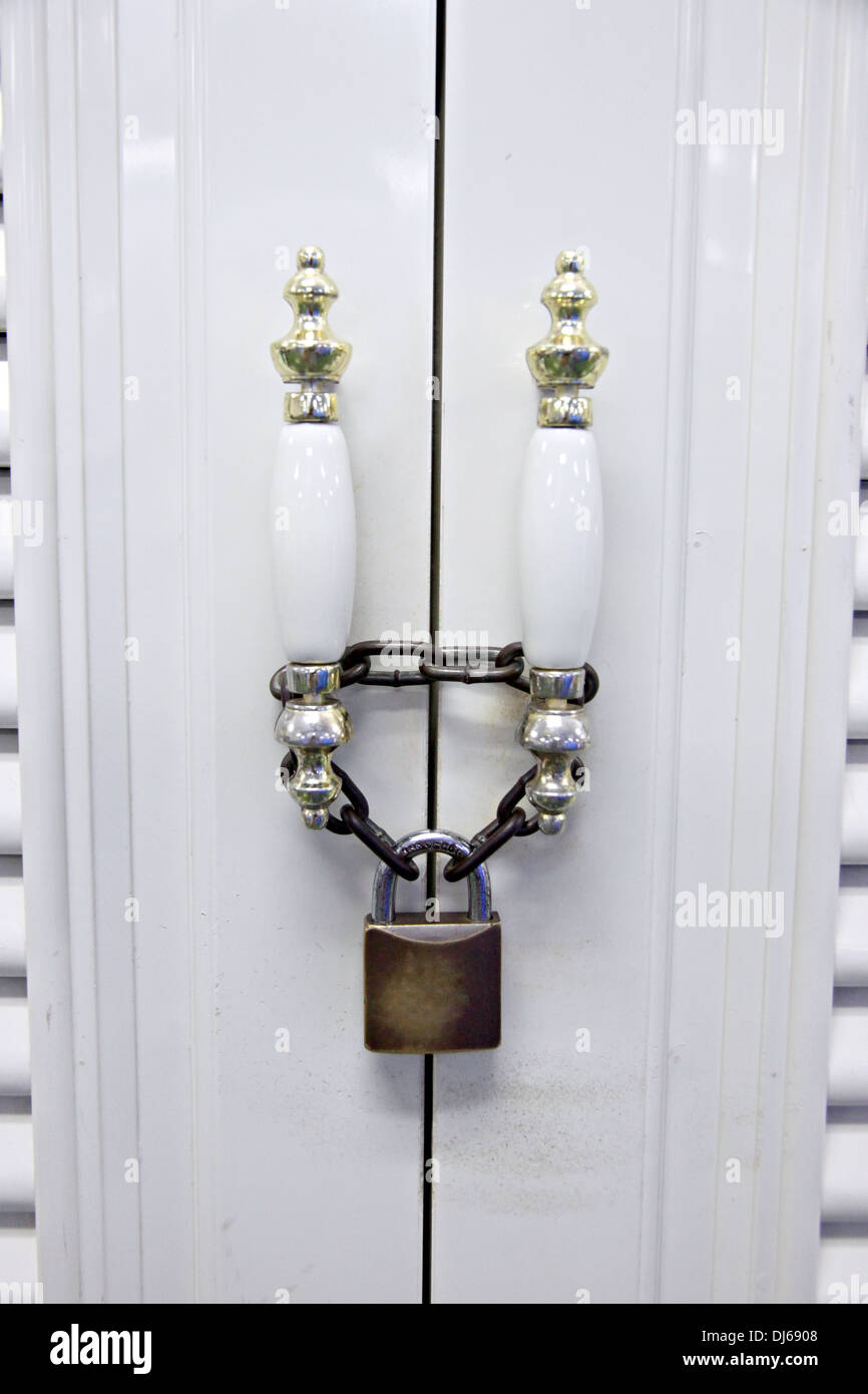 The Picture white door have a lock in key Stock Photo - Alamy