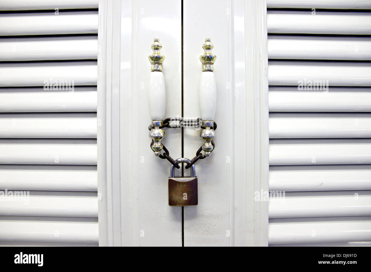 The Picture white door have a lock in key Stock Photo - Alamy