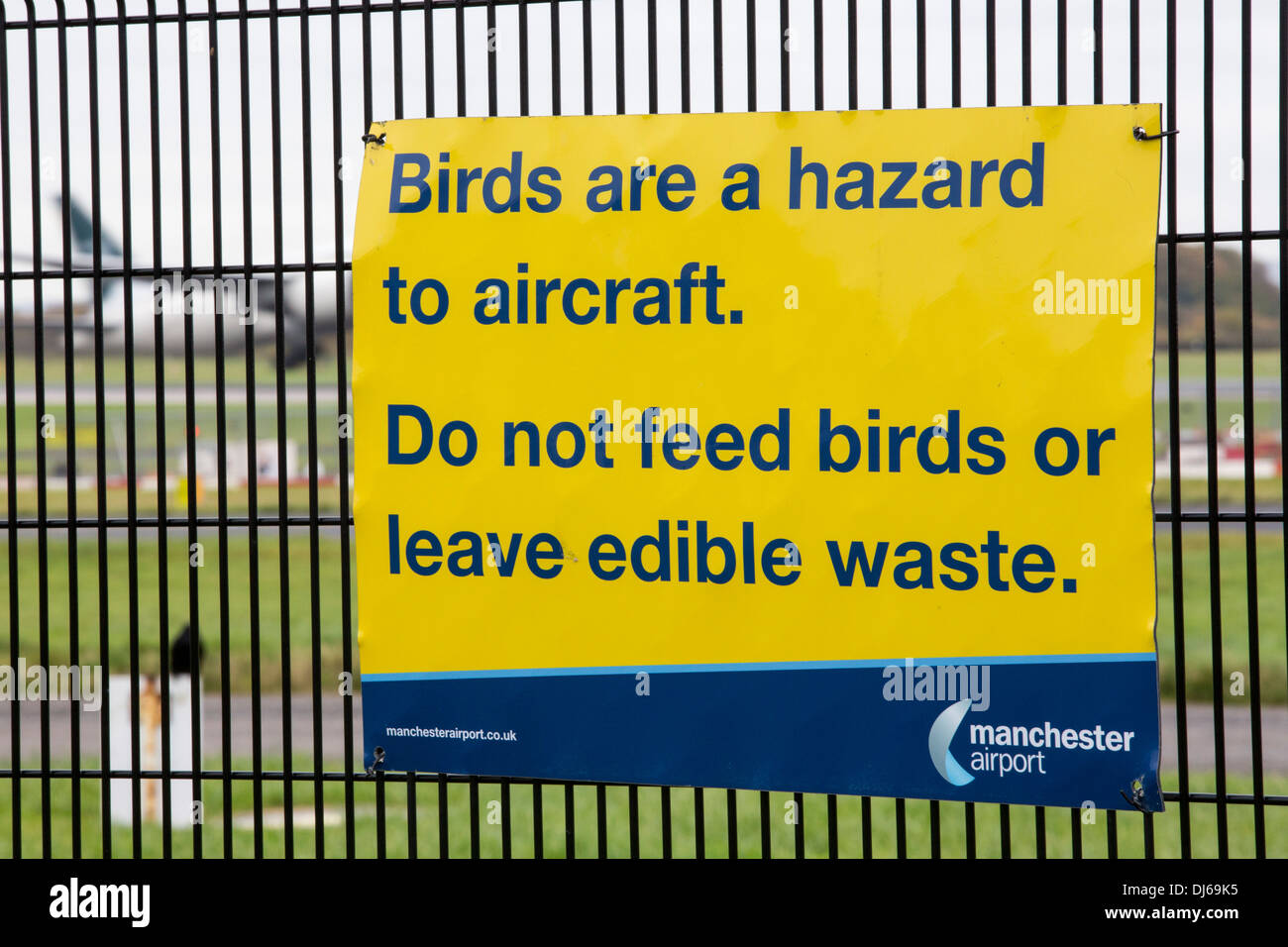 Signs about bird strikes on security fencing at Manchester Airport, UK ...