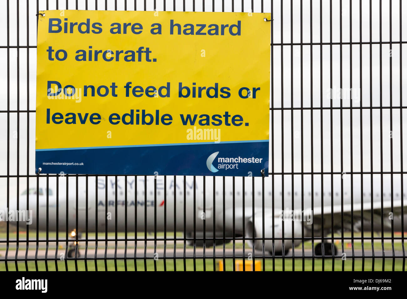 Signs about bird strikes on security fencing at Manchester Airport, UK ...