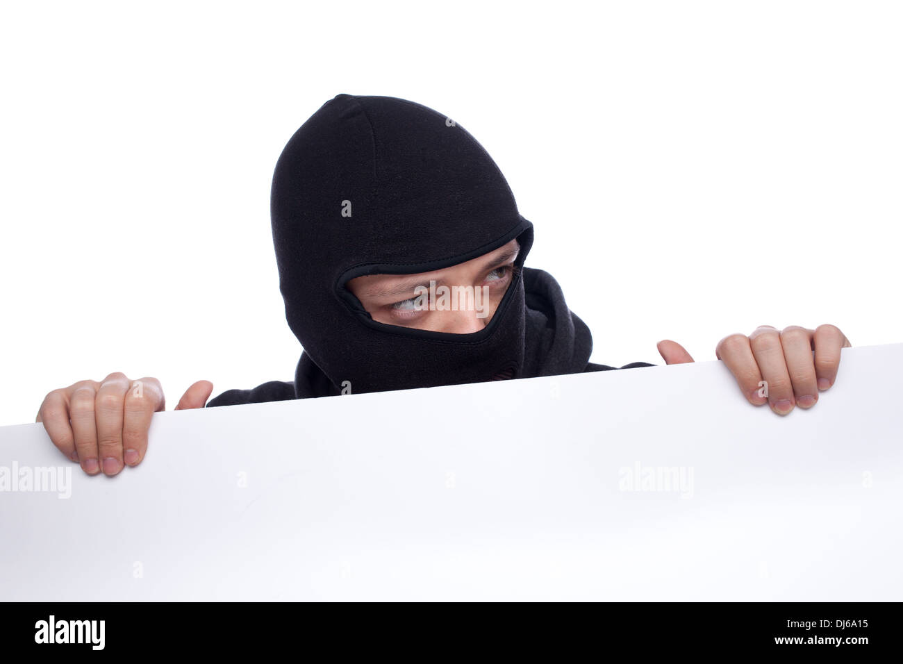 Robber hiding behind a empty white space for text Stock Photo - Alamy