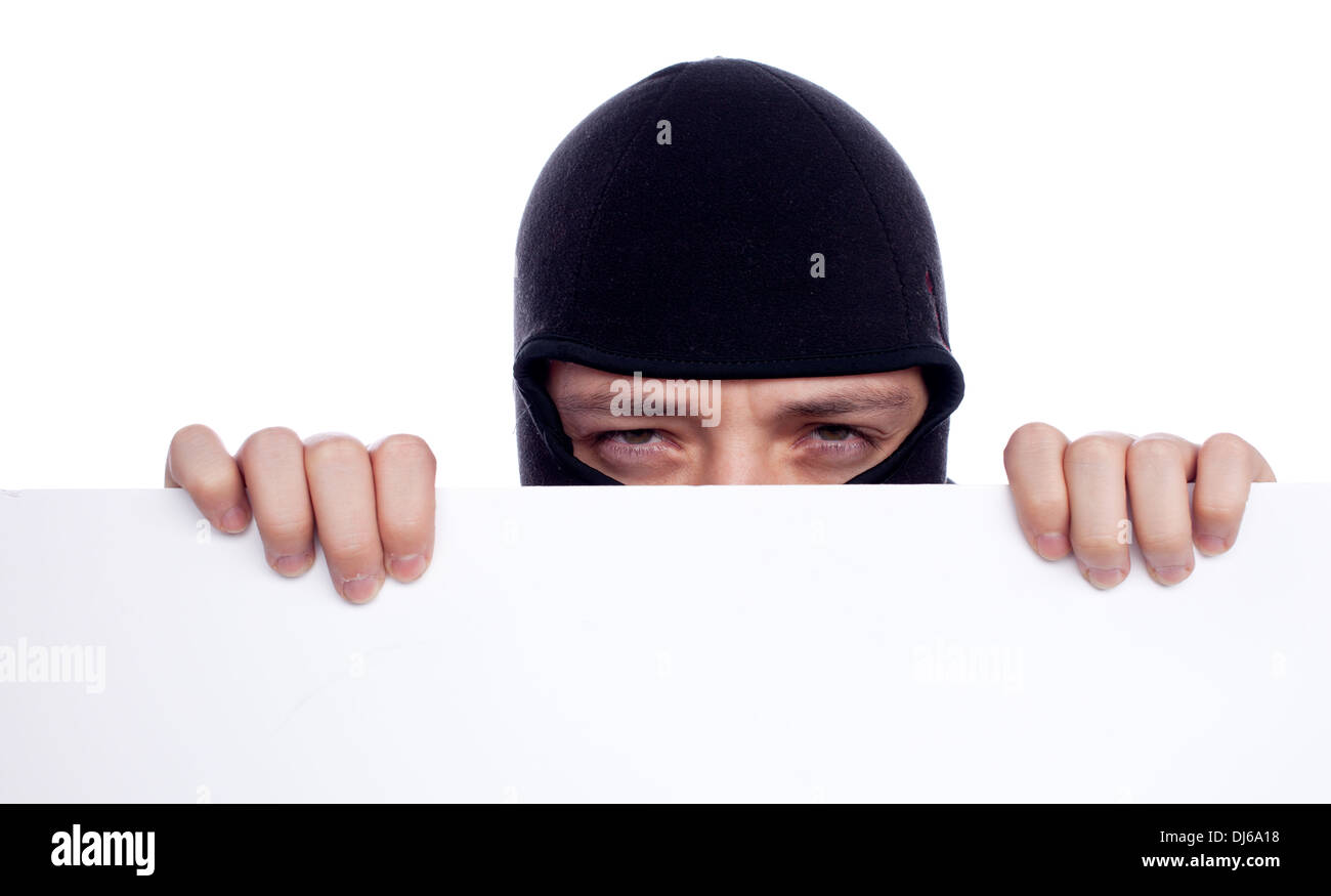 Robber hiding behind a empty white space for text Stock Photo - Alamy