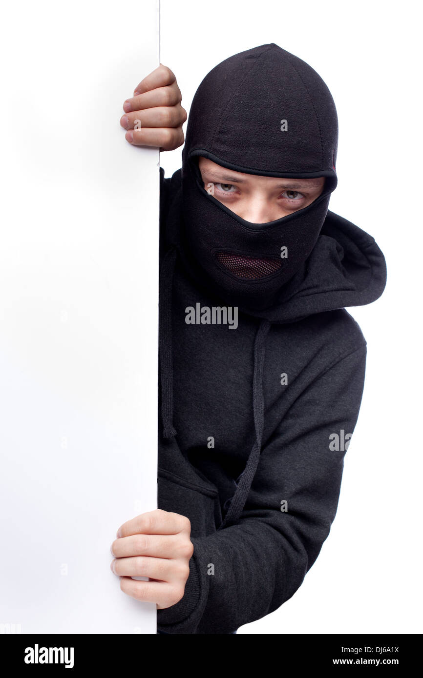 Robber hiding behind a empty white space for text Stock Photo - Alamy
