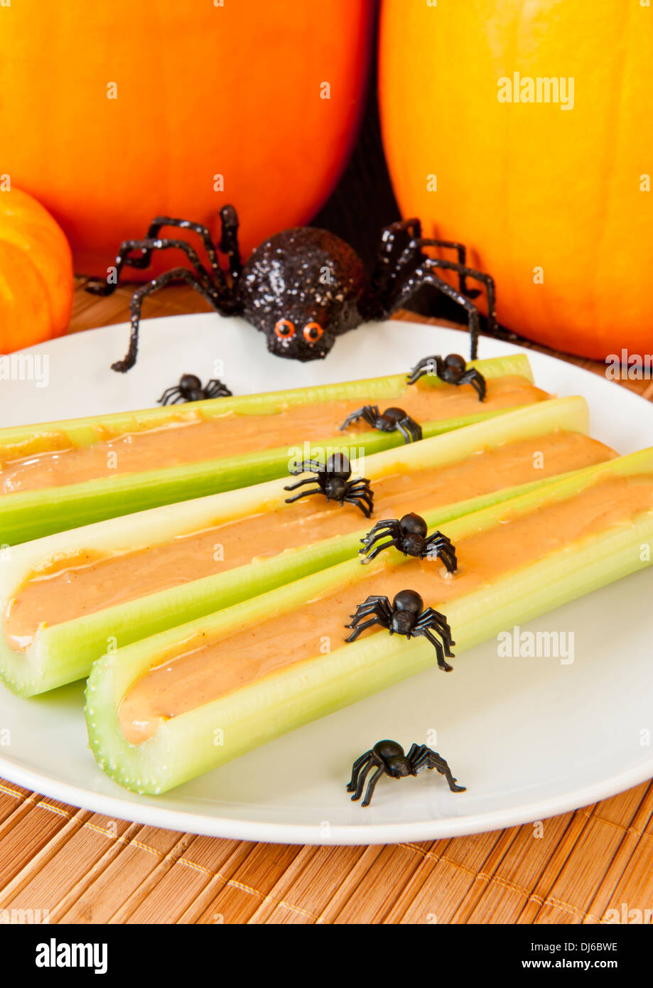 Celery sticks with peanut butter and Halloween spiders Stock Photo - Alamy