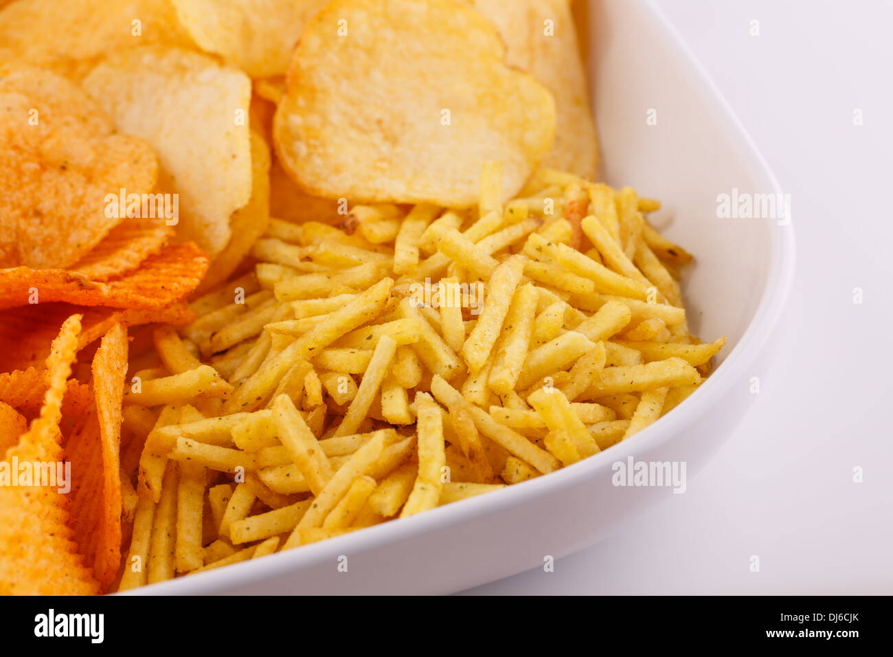 Potato chips in bowl, closeup image Stock Photo - Alamy