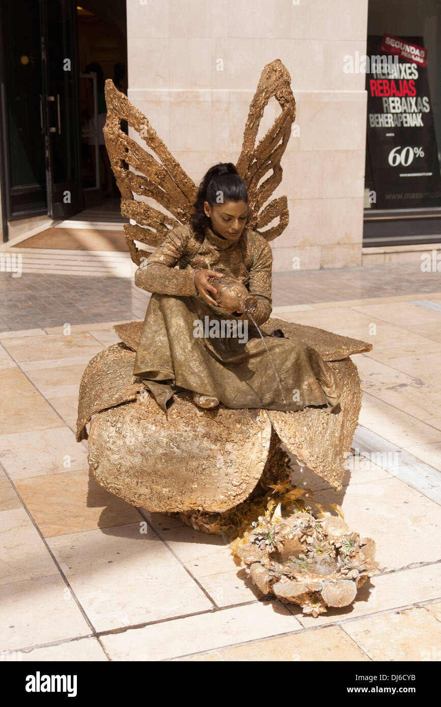 A gold painted female street performer Stock Photo - Alamy
