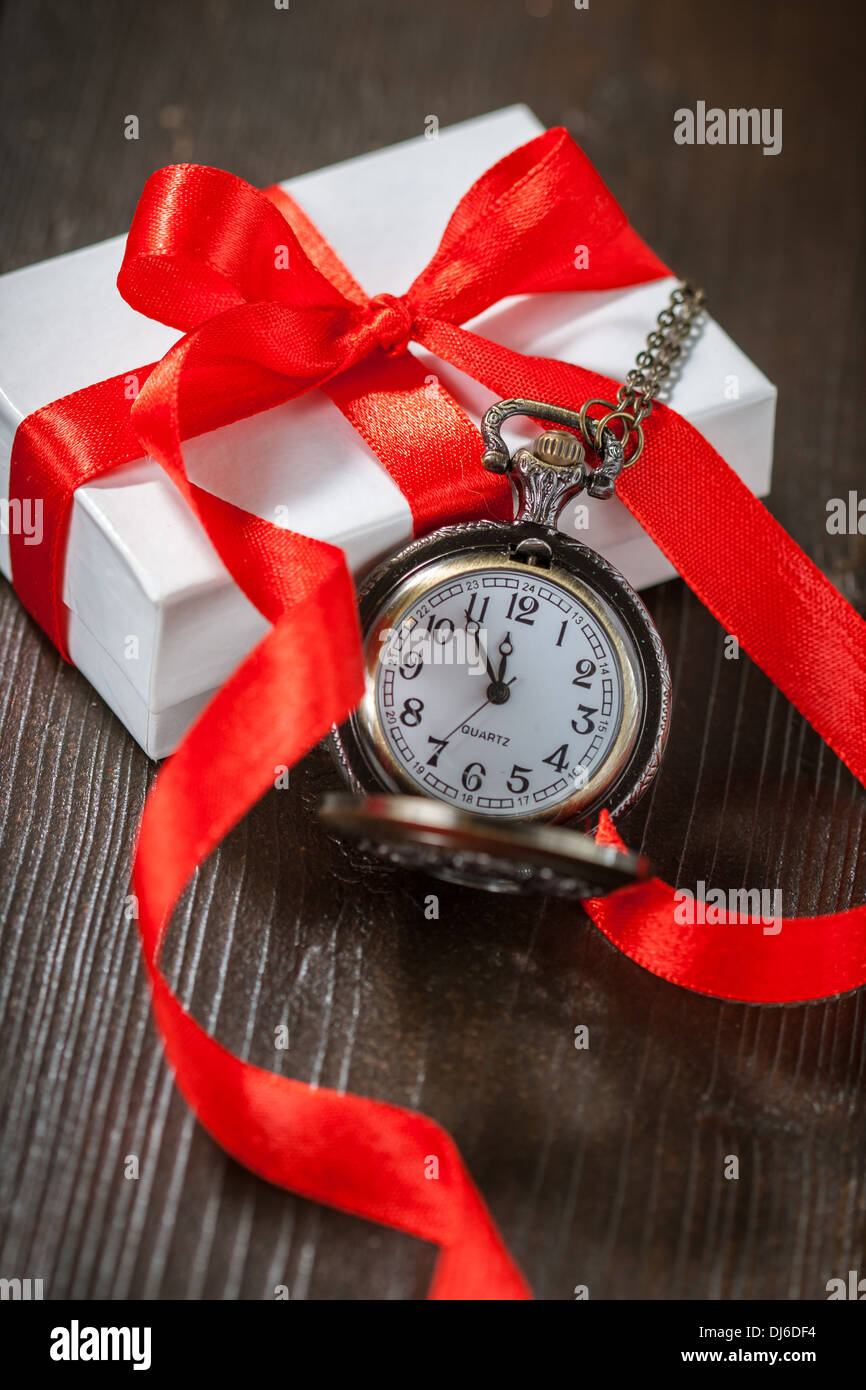 White box with a red bow and pocket watches Stock Photo - Alamy