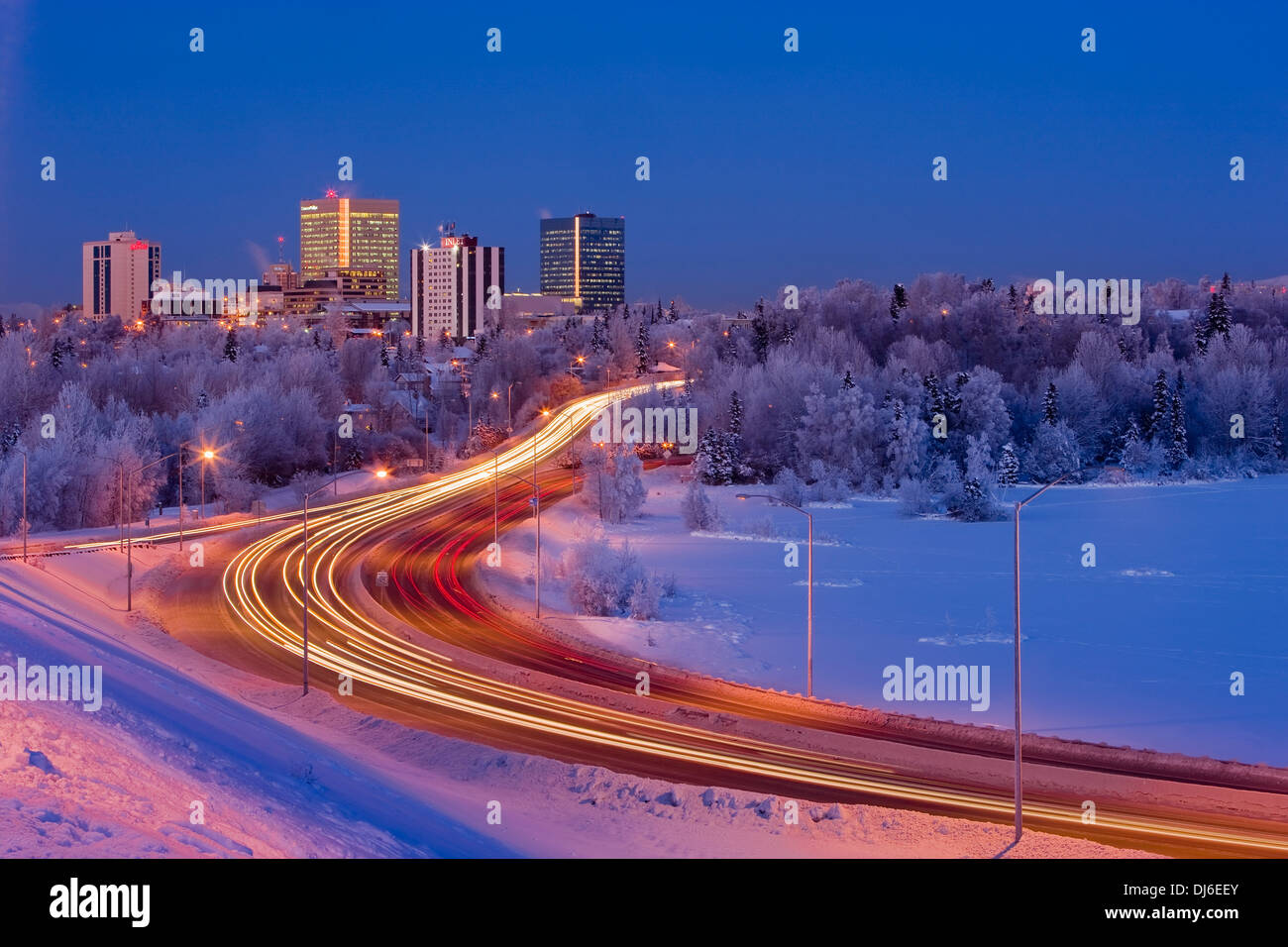 Alpenglow Over The Anchorage Skyline With The Lights From Traffic On ...