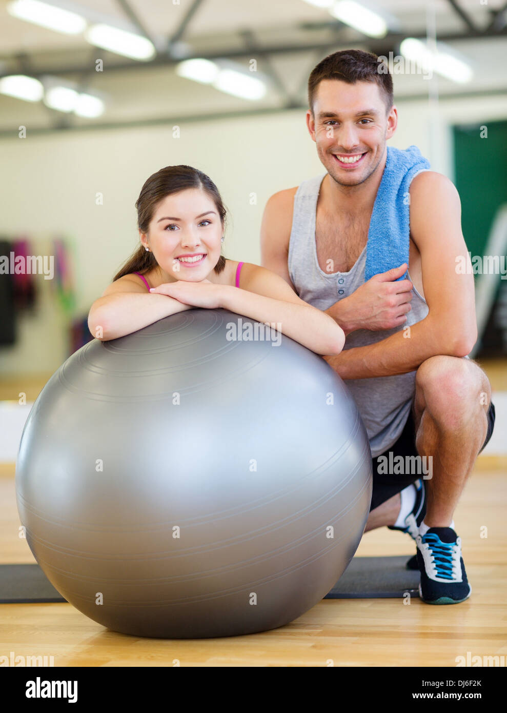 two smiling people with fitness ball Stock Photo - Alamy