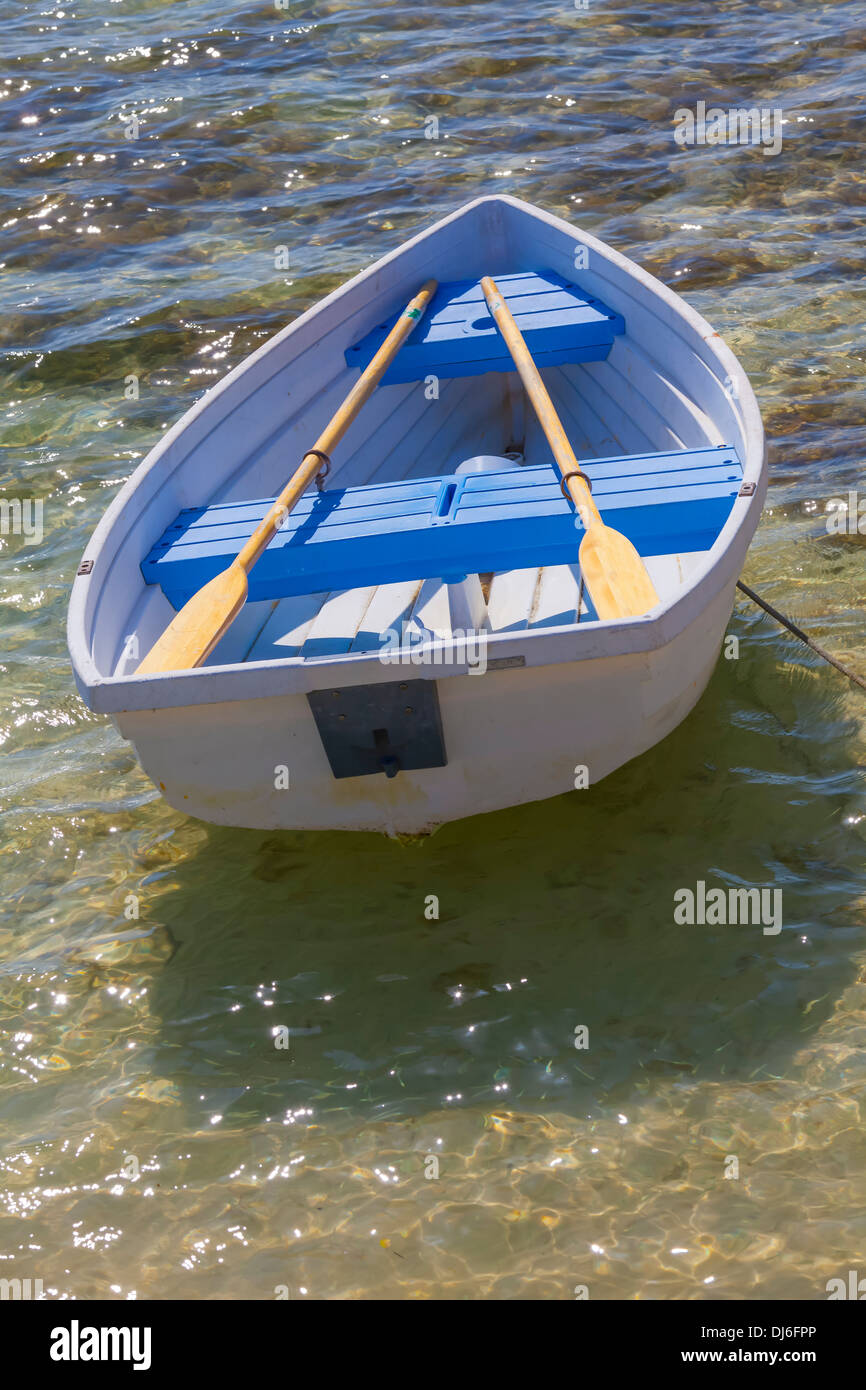 Little rowboat floating in shallow water Stock Photo - Alamy